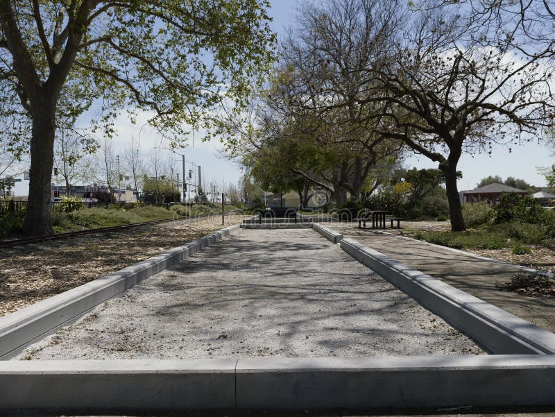 Park bench in a sandy pit stock photo. Image of shade - 322853162
