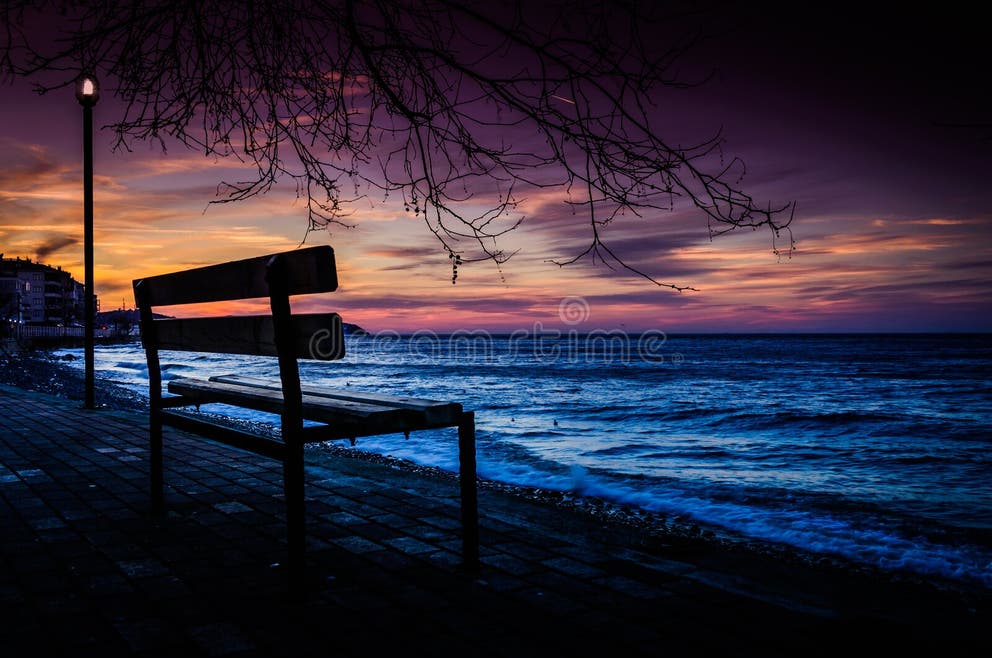 Park Bench on the Sunset Shore Stock Photo - Image of cloudy, peaceful ...