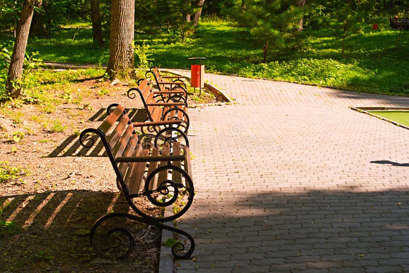 Park bench at sunset stock photo. Image of leaves, green - 97736260