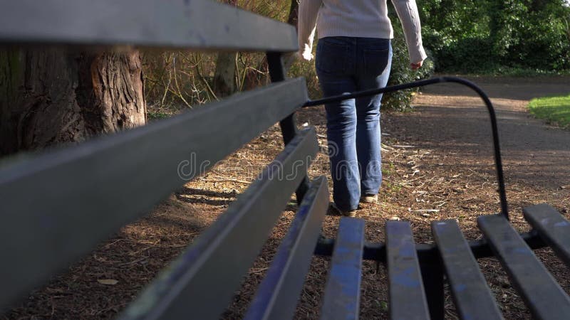 Park Bench with Woman Walking on Pathway Stock Video - Video of healthy ...