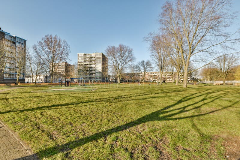 A Park with Buildings in the Background and Green Grass Editorial Stock ...