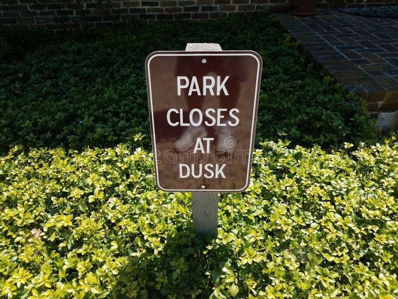 Park Closes at Dusk Sign and Green Plants Stock Photo - Image of closes ...