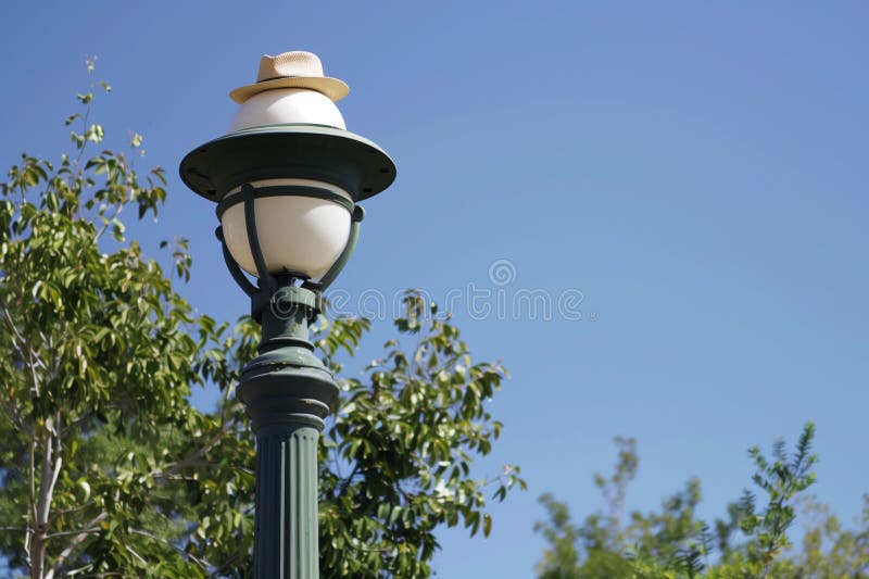 Park Lamp Post with a Hat Perched on Top, Watching Fight Stock Image ...