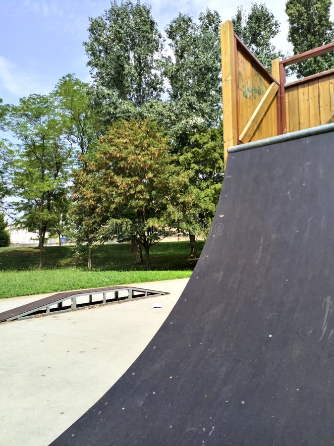 Park in a Residential Area on a Sunny Day Framed by Part of a Half Pipe ...