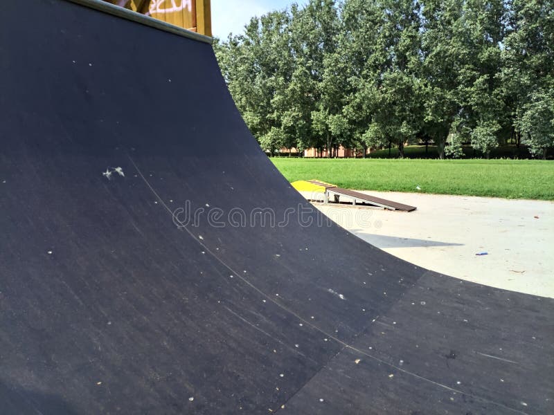 Park in a Residential Area on a Sunny Day Framed by Part of a Half Pipe ...