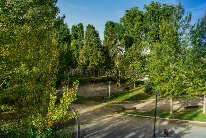 Park with Trees and Benches Along Riverbank Stock Photo - Image of park ...