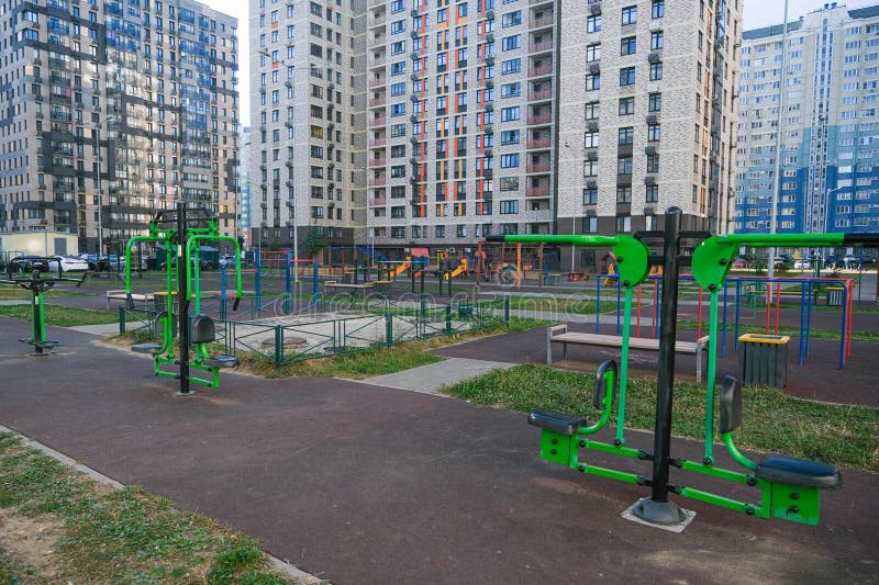 A Park with Two Green Exercise Machines and a Few Benches Stock Image ...