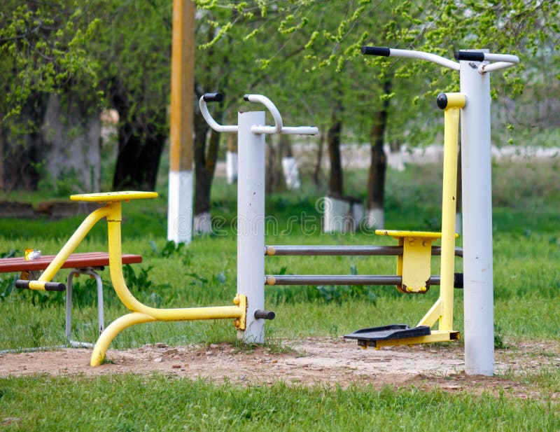 A Park with a Yellow and White Exercise Machine Stock Photo - Image of ...