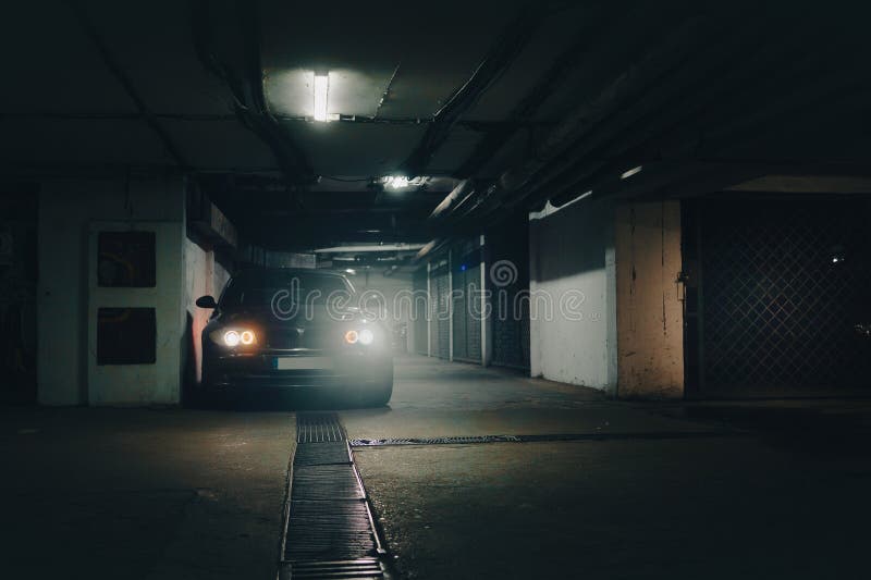 Parked Car with Headlights on in an Underground Garage Stock Image ...
