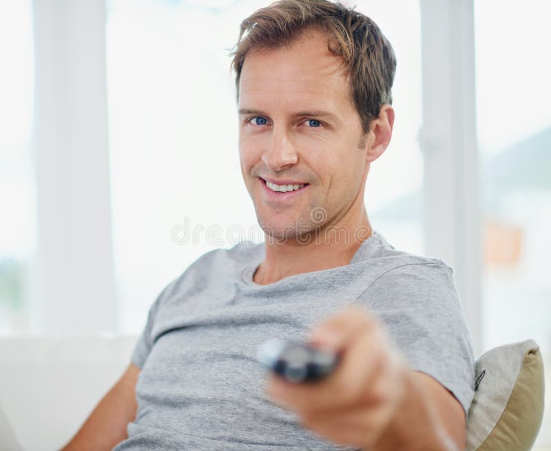 Parked in Front of the Tv. Portrait of a Handsome Man Holding a Remote ...