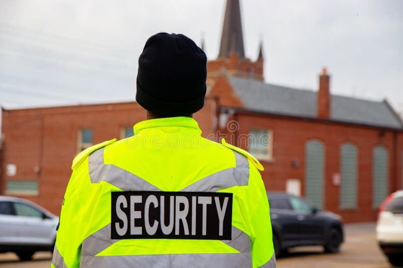 Security Guard Setting Up a Caution Tape To Do Parking Enforcement at ...