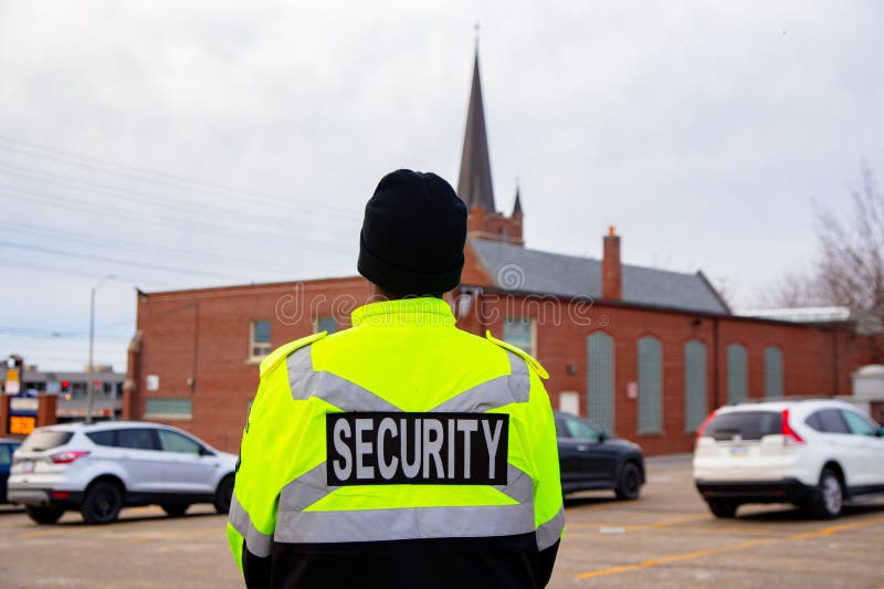 Security Guard Setting Up a Caution Tape To Do Parking Enforcement at ...