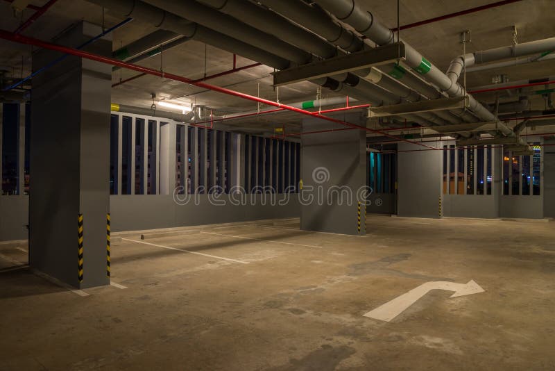 Parking Garage in Modern Building with Warm Lighting at Night. Stock ...