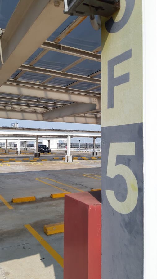 A Parking Garage Scene Features a Large F5 Sign on a Support Column ...