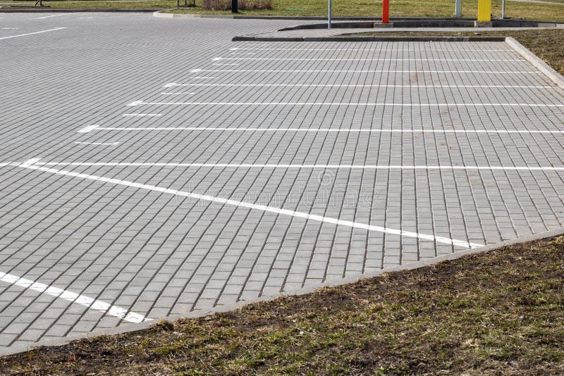 A Parking Lot Made of Bricks, Featuring Distinct White Lines on it ...