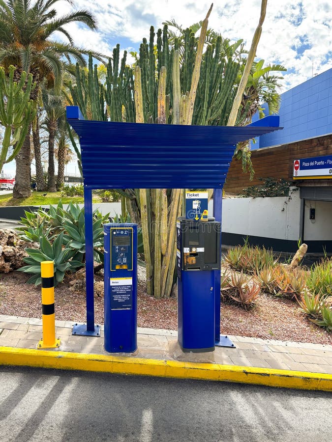Parking Payment Station with Blue Structure and Surrounding Greenery in ...