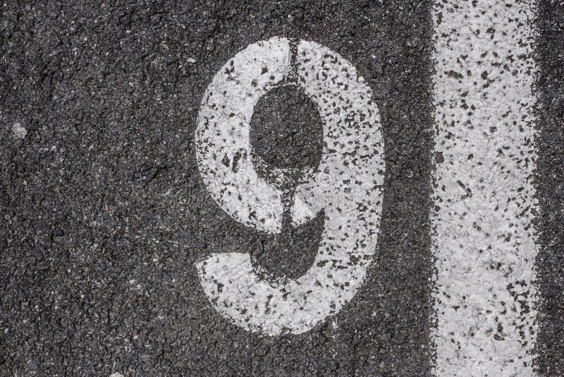 Parking Spot Number Nine Marked with White Paint Stock Photo - Image of ...