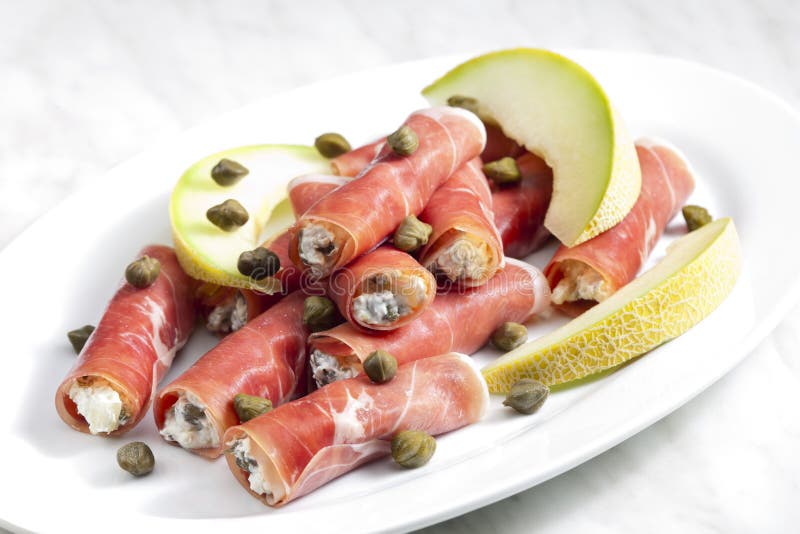 Parma Ham Rolls Filled with Cream Cheese, Galia Melon and Capers Stock ...