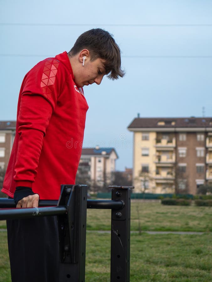 Athlete in Red Top Training Outdoors on Parallel Bars Editorial Stock ...