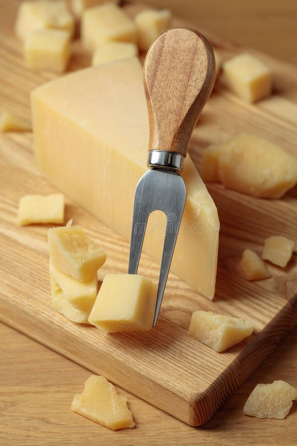 Parmesan Cheese and Fork on a Cutting Board Stock Image - Image of ...