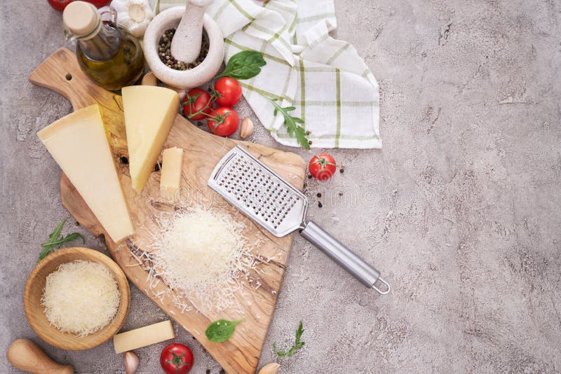 Parmesan Cheese and Grater on a Wooden Cutting Board Stock Image ...