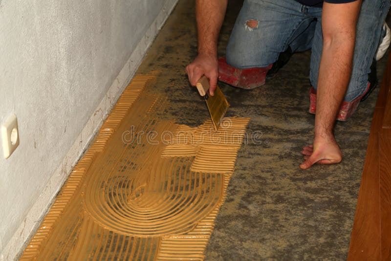 Worker Laying Parquet Flooring. Worker Installing Wooden Laminate ...