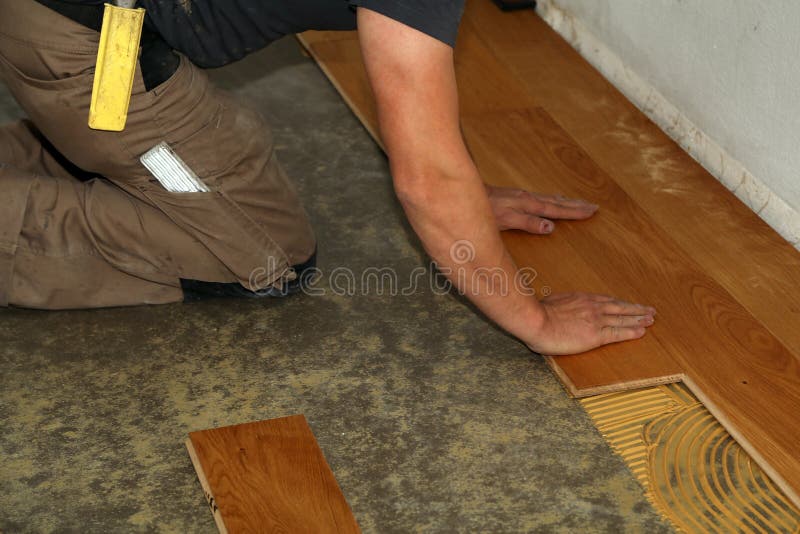 Worker Laying Parquet Flooring. Worker Installing Wooden Laminate ...