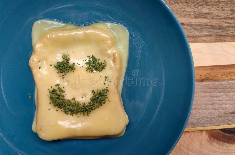 Parsley in the Shape of a Smiley Face on Grilled Cheese on a Blue Plate ...