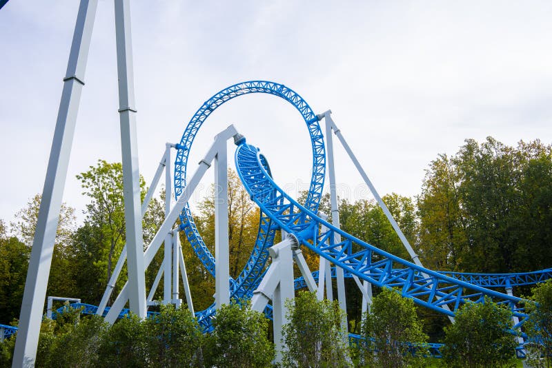 Part of a Blue Rollercoaster in Amusement Park and Green Trees Stock ...