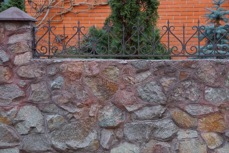 Part of a Brown Stone Fence with Sharp Iron Rods Stock Image - Image of ...