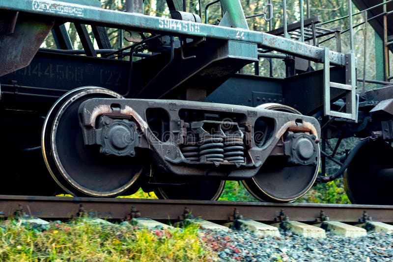 Part of a Freight Car with Massive Wheels during the Movement of the ...