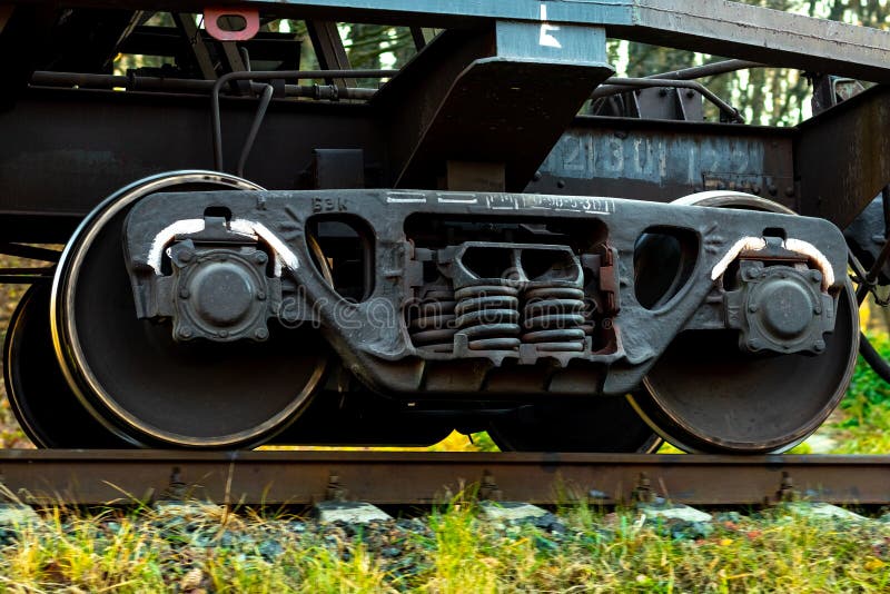 Part of a Freight Car with Massive Wheels during the Movement of the ...