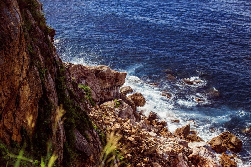 Part of the Hillside Above the Water with Rocks Around. Stock Image ...