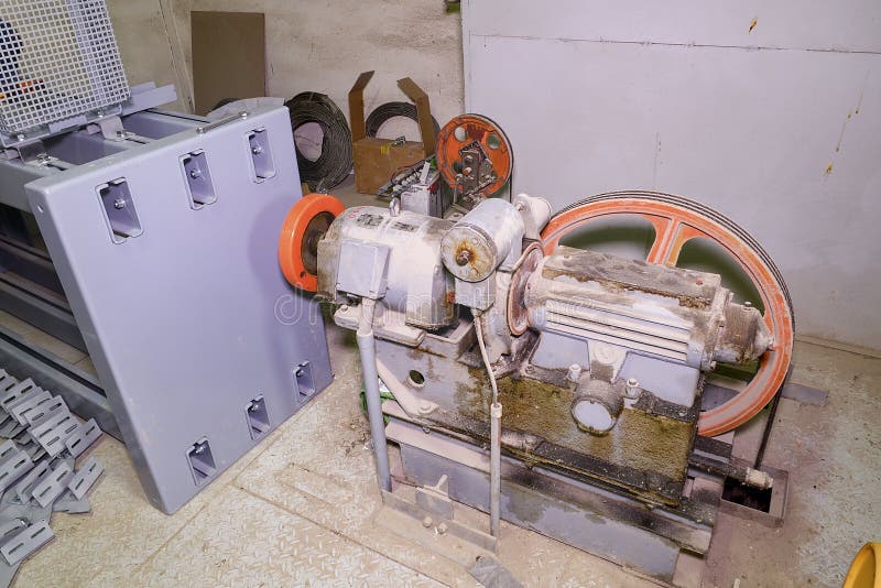 Part of Industrial Lift. Pulley Wheel and Engine in Engine Room ...