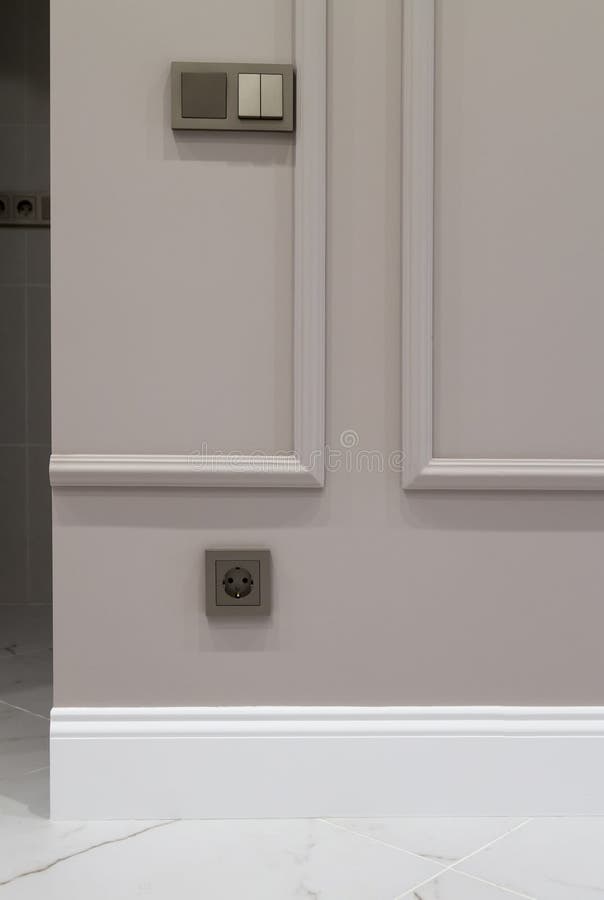 Part of the Interior with an Electrical Outlet on the Brown Wall Above ...