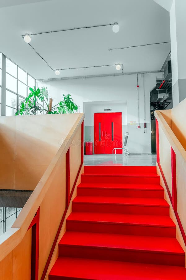 Part of the Interior with a Red Staircase and an Empty Hall with a Red ...
