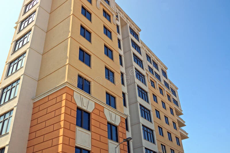 Part of a Large Tall Brown House with Windows on the Sky Background ...