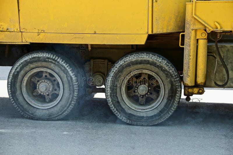 Part of a Large Yellow Truck with Two Wheels on the Asphalt Stock Image ...