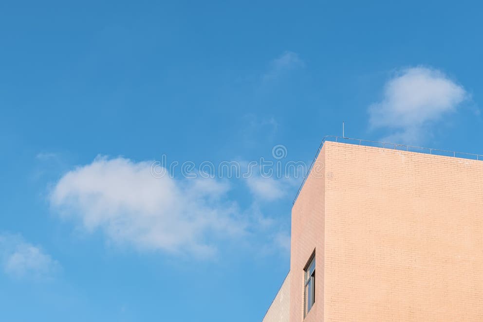 Part of the Light Yellow Building Under the Blue Sky and White Clouds ...