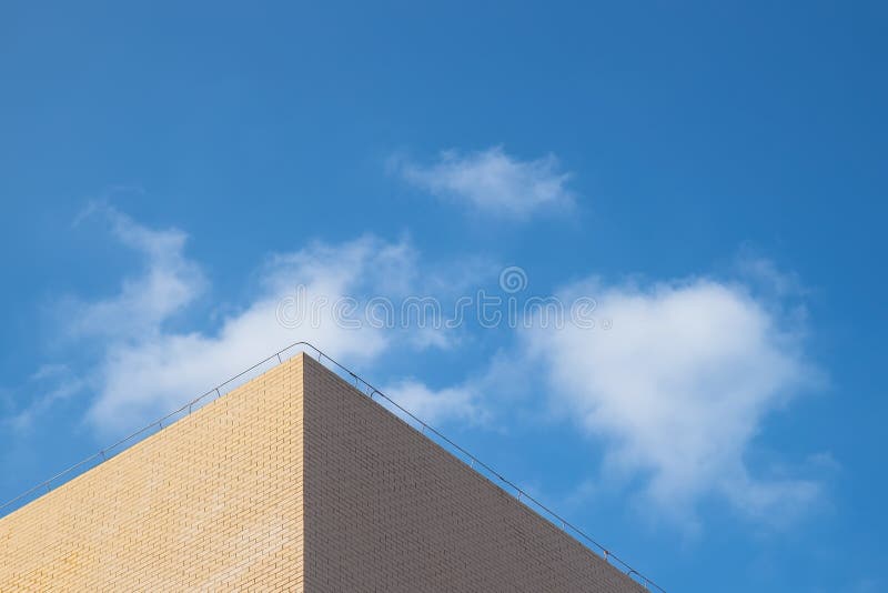 Part of the Light Yellow Building Under the Blue Sky and White Clouds ...