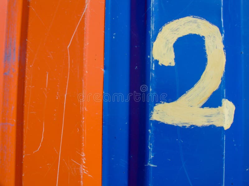 Part of Metal Container Painted Orange and Blue with Number 2 Written ...