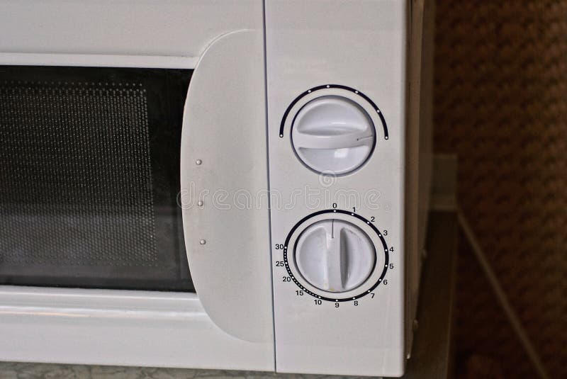 Part of a Microwave Oven with Two Round Plastic Handles Controls Stock ...