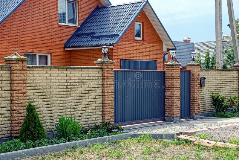 Part of a Modern Brick House Behind a Fence with an Iron Gate Stock ...