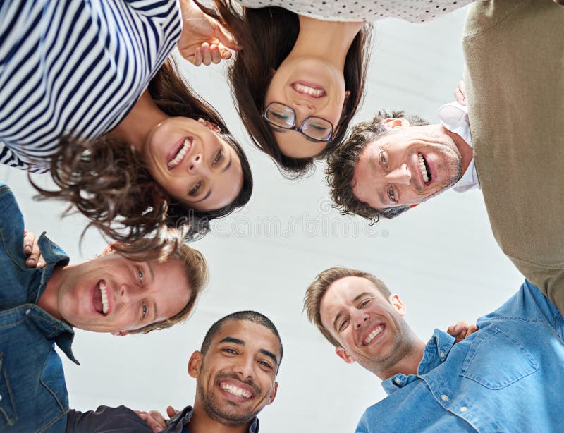 Part of a Motivated Team. Low Angle Shot of a Team of People Smiling ...