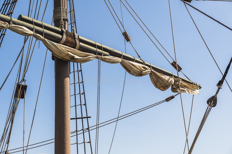 Part of an Old Ship S Mast with Ropes and Tied Sails Against a Blue Sky ...