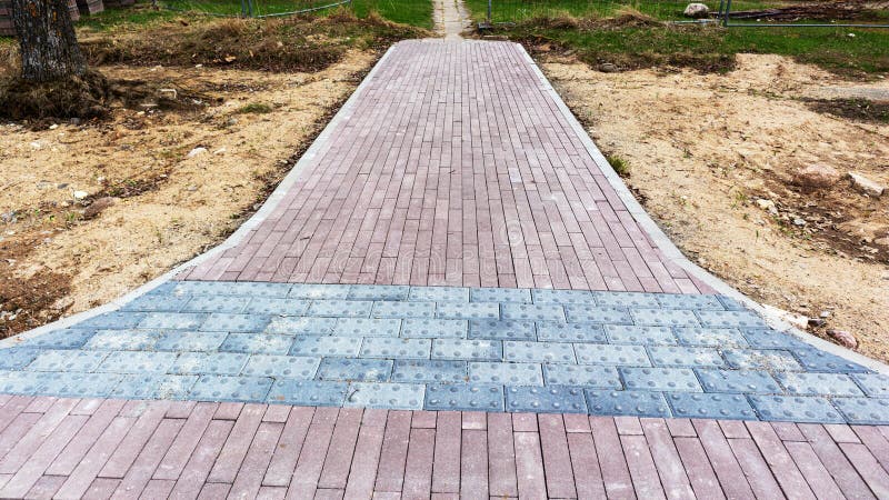 Part of the Pavement of the Construction Site with Repair Work and Red and Gray Fragments of ...