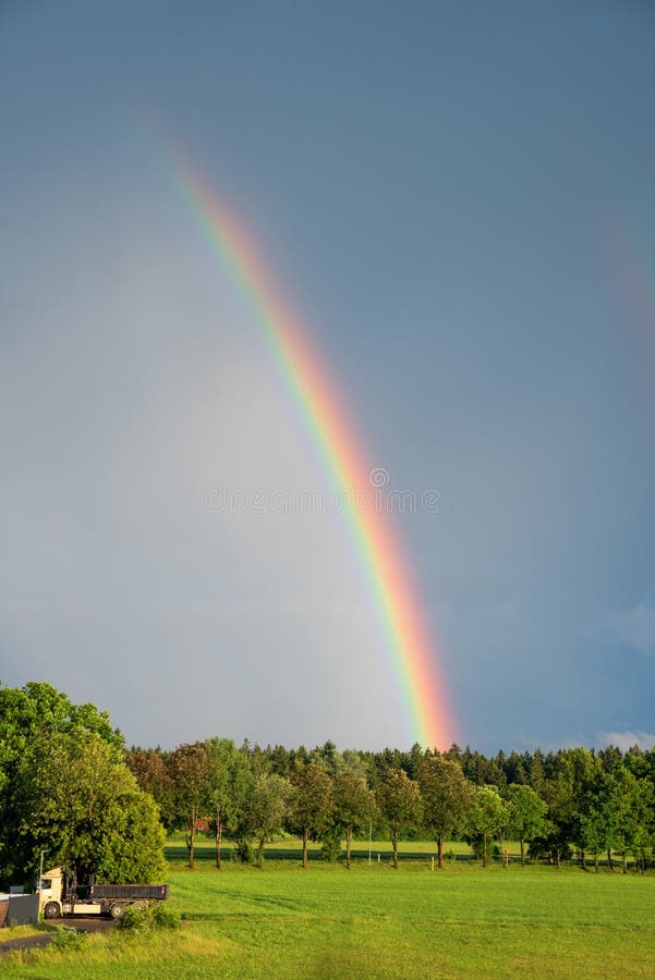 Part of a Rainbow Over Green Landscape Stock Photo - Image of space ...