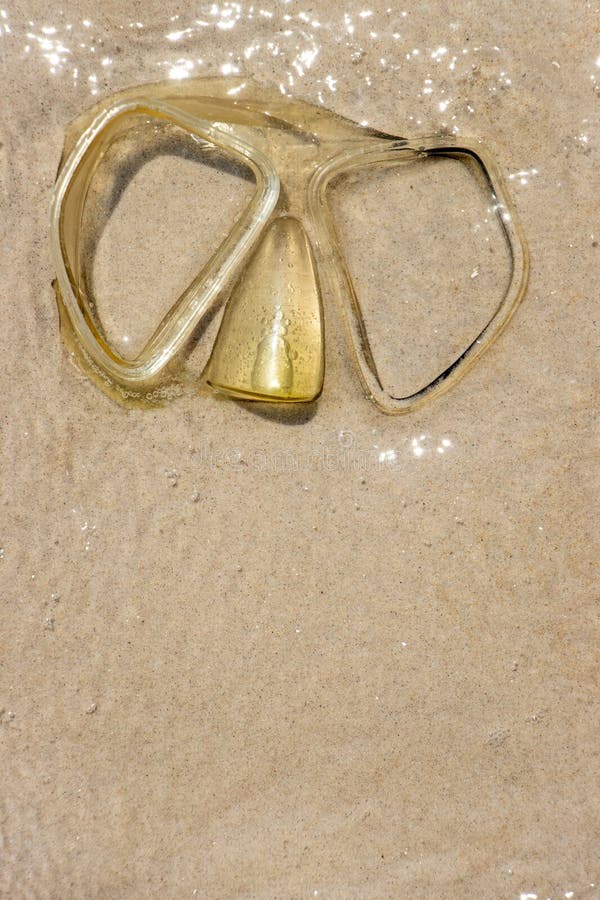 A Part of Snorkel Goggles Lying in the Sand on the Sea Beach Stock ...