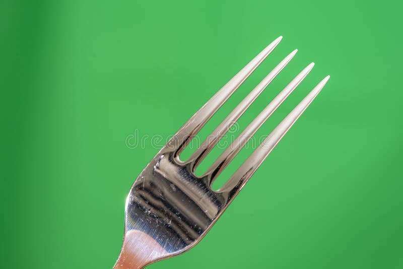 Part of Stainless Steel Fork with 4 Teeth Under Green Background Stock ...
