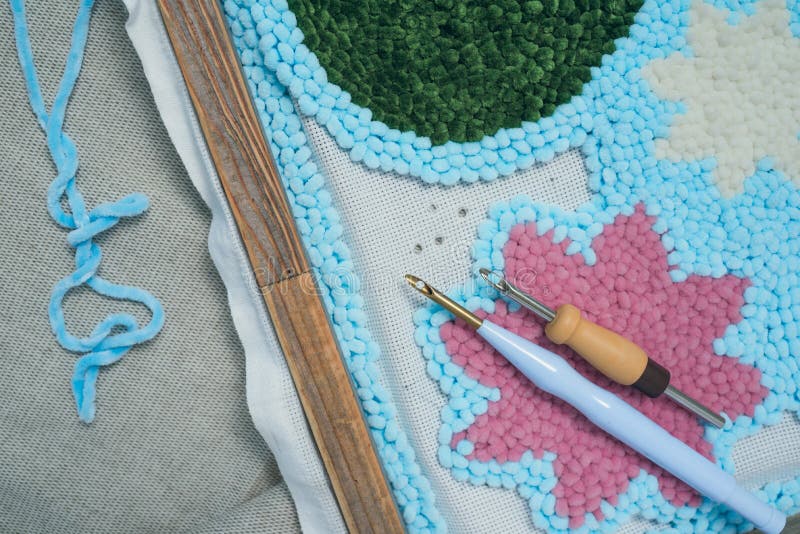 View of a Punch Needle with a White Velour Thread on the Background of Embroidery Project in ...